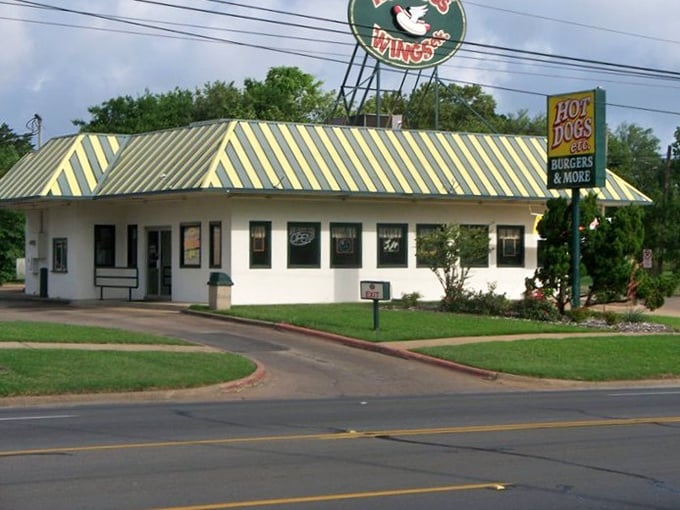 That striped yellow roof isn't just eye-catching—it's a beacon for hot dog enthusiasts who appreciate the simple perfection of a well-dressed frank.