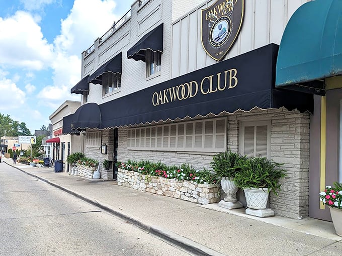 The Oakwood Club's elegant façade whispers "special occasion" while the neon sign winks "come as you are."
