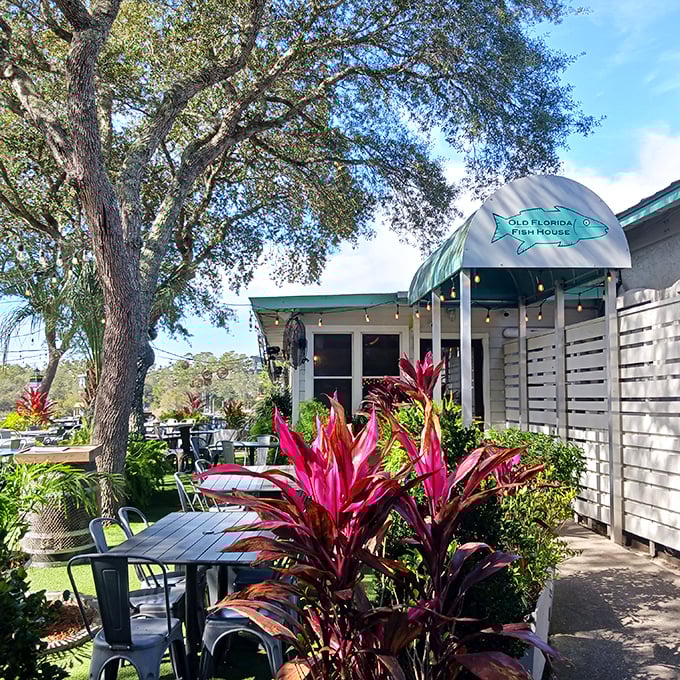 Old Florida Fish House's garden seating looks like it was designed by Mother Nature herself – with a little help from string lights.