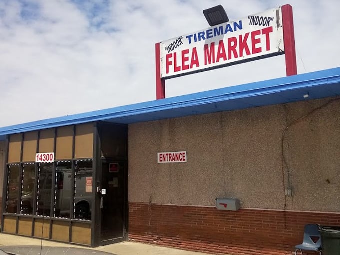 Tireman's no-frills "Indoor Flea Market" sign tells you exactly what you need to know—authentic urban bargain hunting awaits inside.