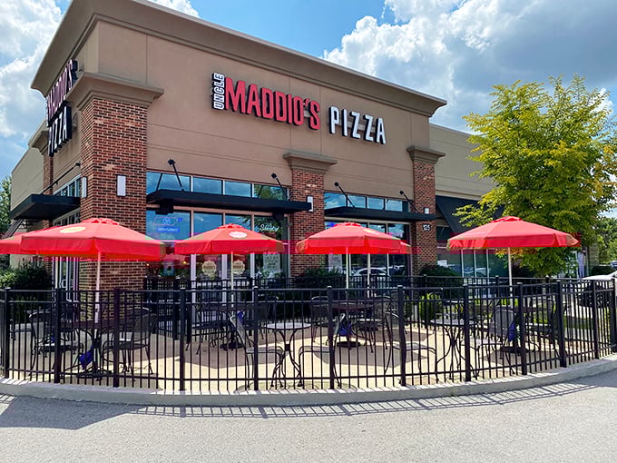 Uncle Maddio's modern storefront promises pizza personalization. Those red umbrellas aren't just for show—they're for pizza enjoyment.