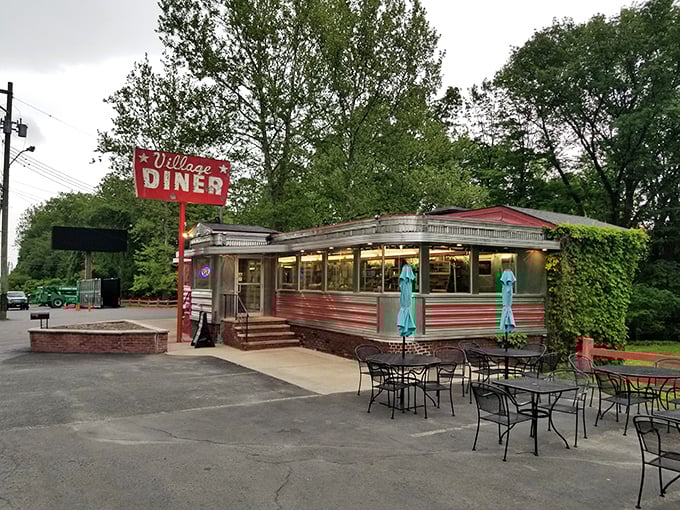 Nestled among trees like a silver jewel, this classic diner car whispers tales of simpler times.