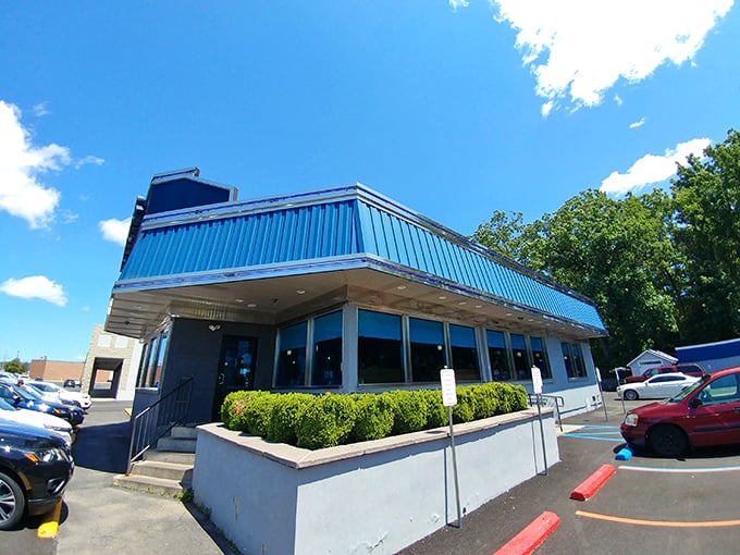 The bright blue trim of East Penn Diner pops against the clear Pennsylvania sky – a colorful promise of classic American fare inside.