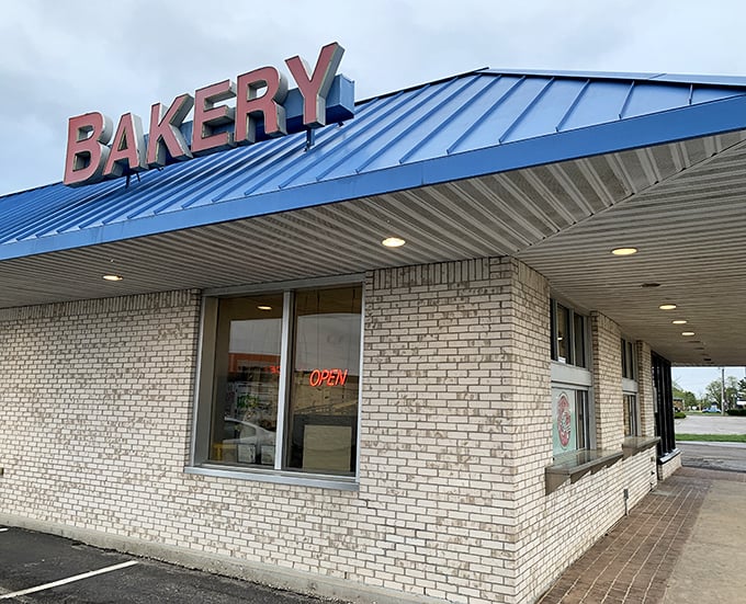 Simple brick, bold letters, and a blue roof – the architectural equivalent of "we don't need fancy, our donuts speak for themselves."