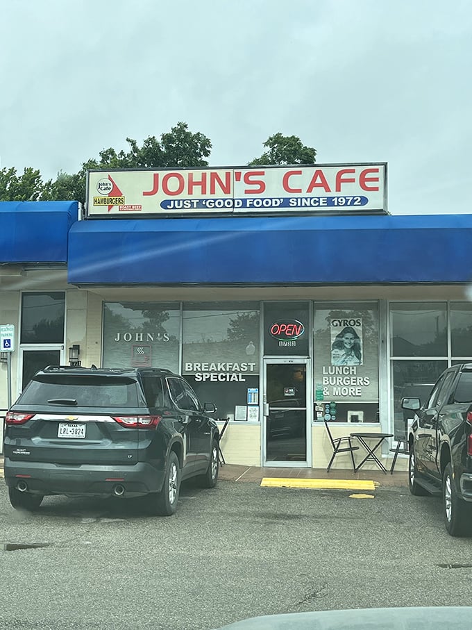 The blue awning of John's Cafe welcomes hungry travelers with the promise of breakfast specials and burger bliss.