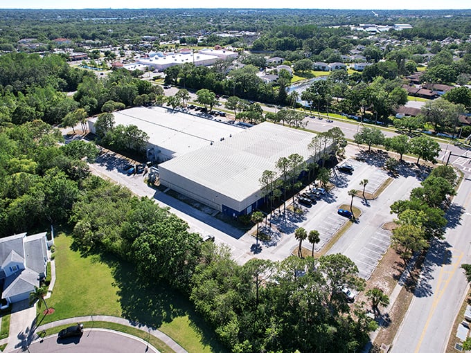 From above, Oldsmar's industrial complex plays hide-and-seek with nature—concrete jungle meets actual jungle in Florida's business-casual landscape.