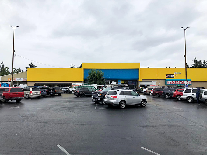 The big yellow building of Oregon Flea Market beckons shoppers with promises of endless treasures waiting inside.