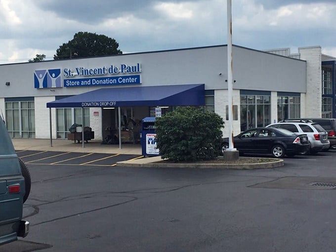 The blue donation awning marks the spot where generosity begins and bargain hunting dreams take flight.