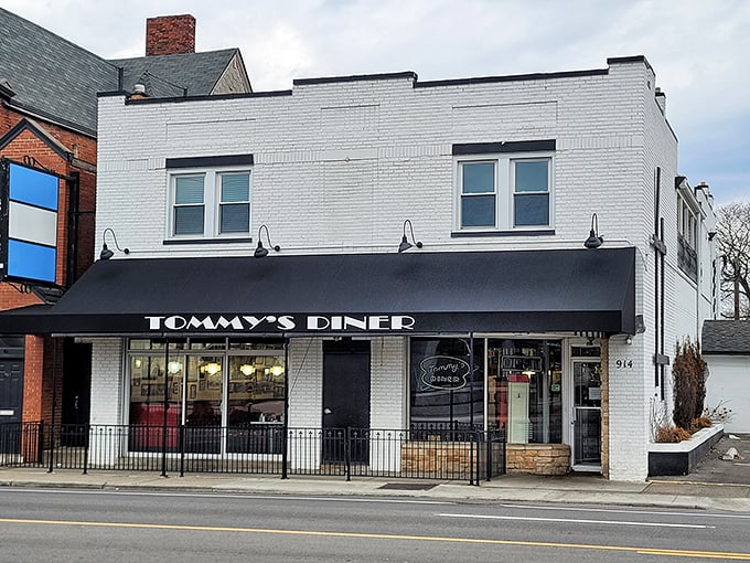 Classic white brick and black awnings whisper "real diner" louder than any fancy marketing campaign ever could.