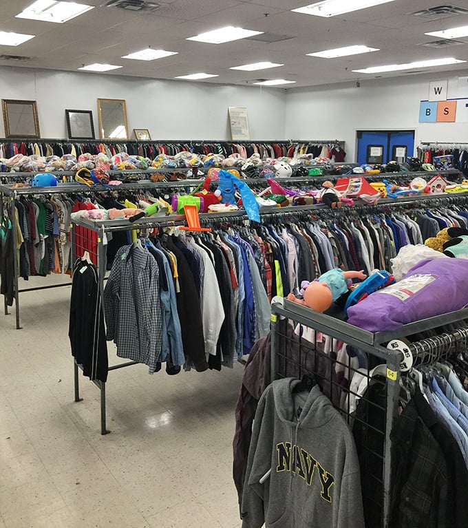 Inside these bright aisles, clothing racks stretch like a rainbow of second chances and style.
