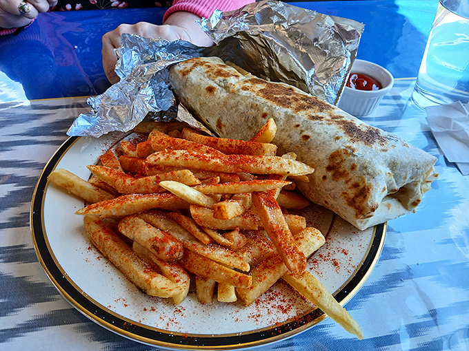 This Adana wrap isn't just lunch—it's a revelation wrapped in flatbread. Those seasoned fries with paprika are the perfect sidekick.