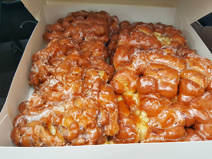 These apple fritters aren't just fried dough – they're glistening monuments to what happens when apples, cinnamon, and glaze achieve perfect harmony.