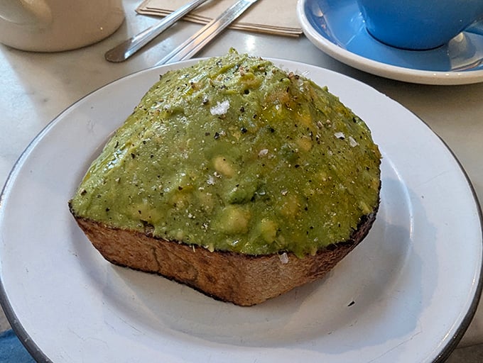 This mountain of avocado on toast isn't just breakfast, it's edible architecture—a testament to what happens when simple ingredients meet serious craftsmanship.