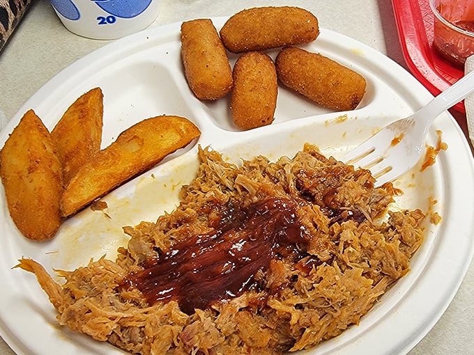 Pulled pork perfection with that signature sauce – this is the plate that launches hundred-mile road trips and family traditions.