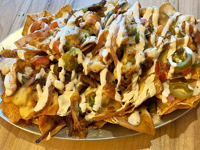 BBQ nachos that could make a vegetarian weep with temptation. Layers of pulled pork, jalapeños, and cheese sauce creating a perfect storm of flavor. 