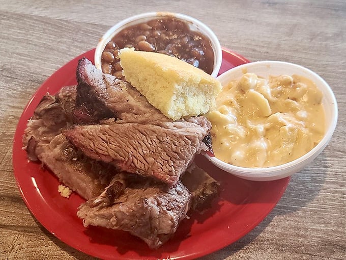 Brisket with that perfect pink smoke ring alongside mac and cheese and baked beans. This plate isn't just lunch—it's a Southern symphony.
