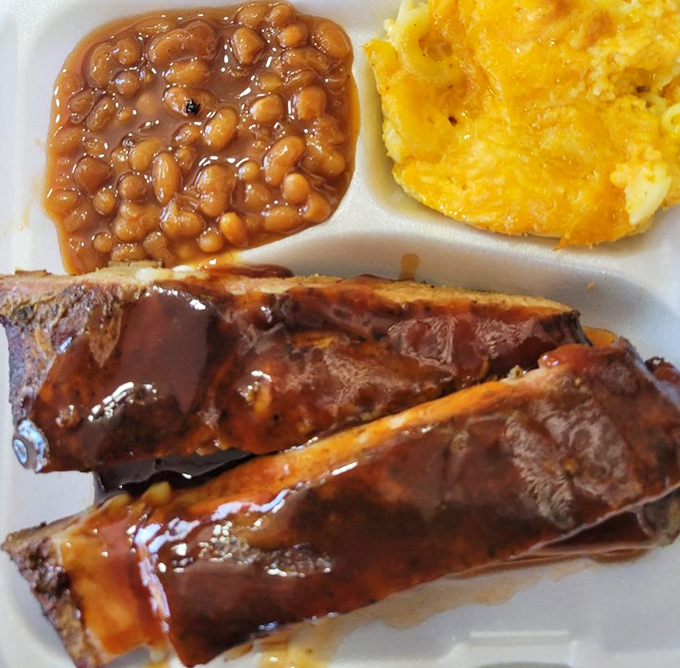 These ribs don't just fall off the bone – they practically leap onto your fork, glistening with that perfect sticky glaze.