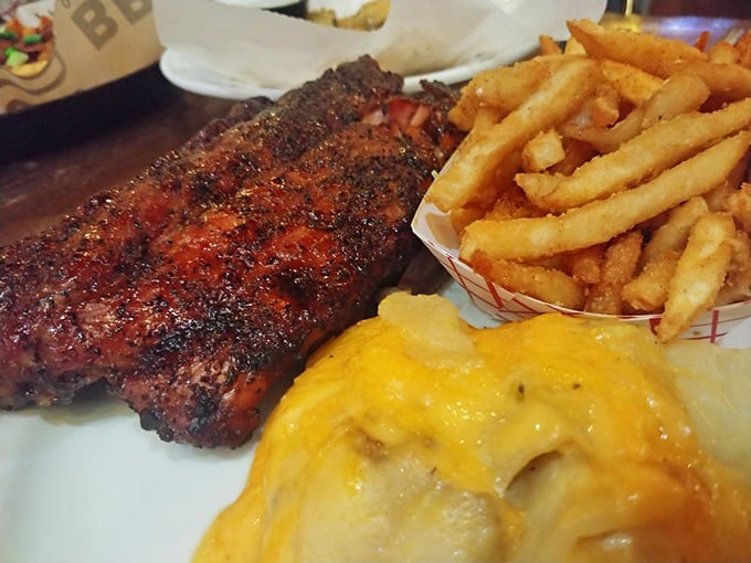 Those aren't just ribs—they're edible works of art with a smoke ring that would make Saturn jealous. The mac and cheese looks like it's plotting to steal the show.