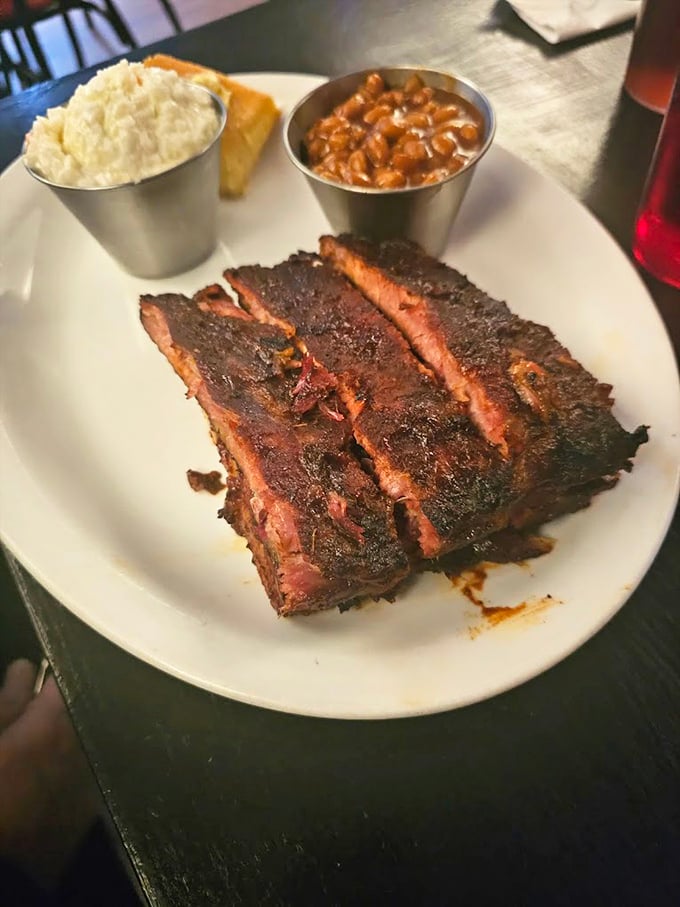Behold the holy trinity of barbecue – perfectly barked ribs, creamy mac and cheese, and beans that have clearly been introduced to their meaty cousins.