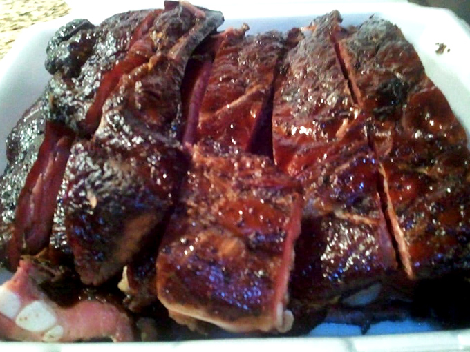 These ribs aren't just cooked—they're transformed. That bark, that smoke ring, that glistening surface... poetry on a plate.