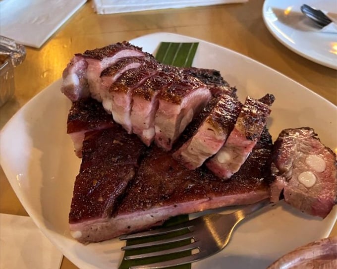 Behold the star of the show: ribs with a bark so perfect it deserves its own Grammy. The pink smoke ring is BBQ's equivalent of a Rolex—pure status.