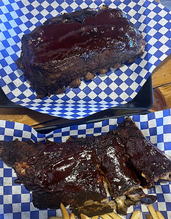 These baby back ribs don't just fall off the bone—they practically jump onto your fork, glistening with that sticky-sweet sauce.