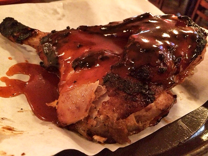 This chicken quarter isn't just cooked – it's been transformed into a glistening masterpiece that makes you question all other barbecue experiences.