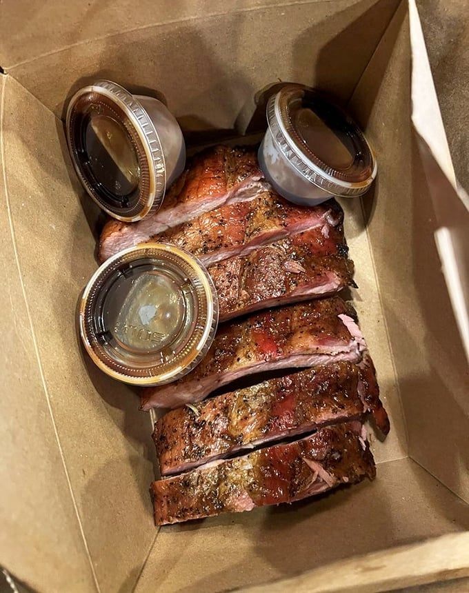 These ribs don't just fall off the bone—they practically leap into your mouth. The perfect pink smoke ring and spice-crusted exterior tell you someone's been paying attention.