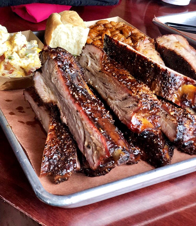 These ribs don't just fall off the bone—they practically leap toward your mouth, flaunting that perfect pink smoke ring BBQ dreams are made of.