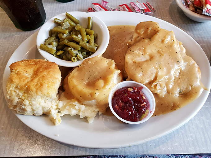 Behold: the turkey and gravy that launched a thousand food comas. That biscuit isn't just a side—it's the co-star of this comfort food show.