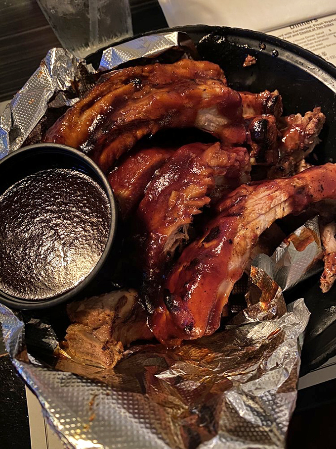 These baby back ribs aren't just falling off the bone—they're practically volunteering to jump onto your fork. The sauce cup is merely a formality.