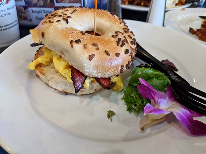 This breakfast sandwich on an everything bagel isn't just a meal—it's edible architecture with layers of egg and bacon.