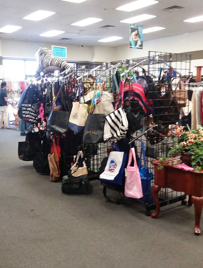 Handbag heaven! This rotating display of purses and totes represents thousands of shopping trips, special occasions, and fashion eras all hanging together in secondhand harmony.
