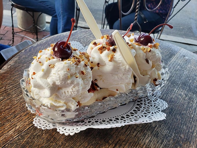 Banana splits here aren't just desserts, they're architectural achievements. Three scoops nestled in a crystal boat, topped with enough whipped cream to make a cloud jealous.
