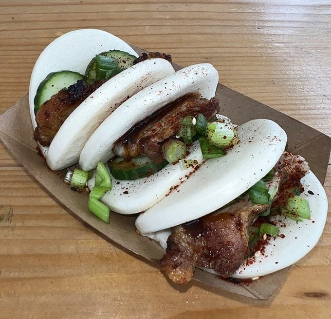 These bao buns aren't just food; they're cloud-like vessels of joy, stuffed with savory meat and fresh cucumber that'll haunt your dreams for weeks.