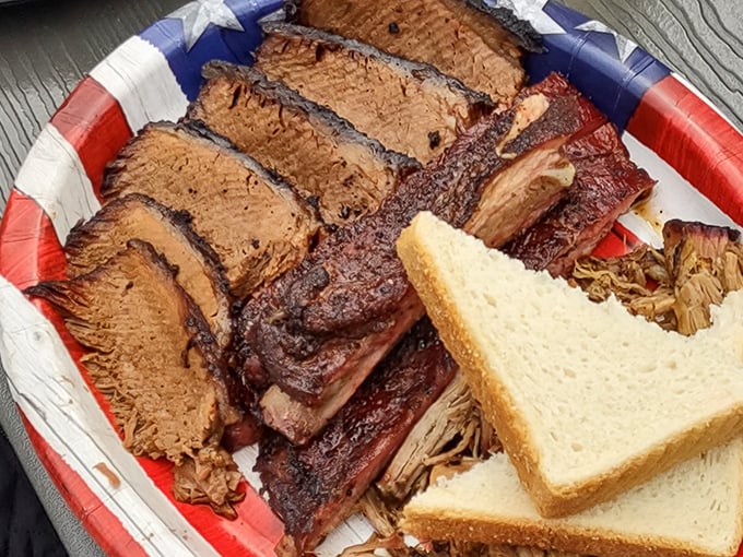 Behold the brisket in all its glory—each slice showcasing that perfect pink smoke ring that barbecue aficionados dream about at night.
