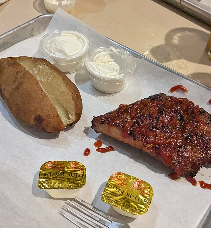Brisket and potato perfection on a tray. That bark, that smoke ring—it's the kind of meat that makes vegetarians question their life choices.