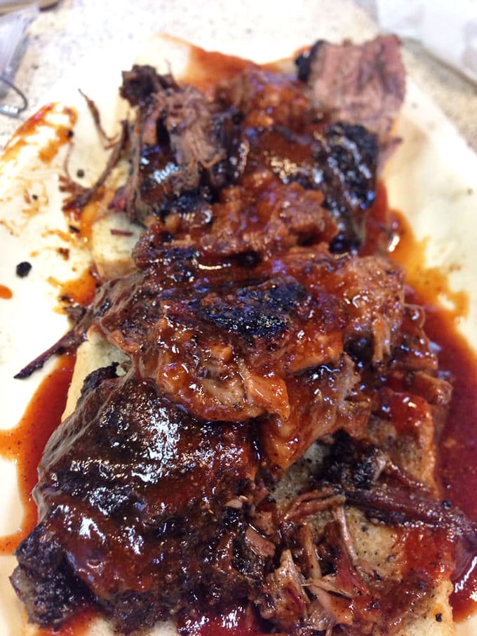 Behold the burnt ends – those twice-smoked brisket nuggets with their blackened exterior and melt-in-your-mouth interior. Poetry on a plate.