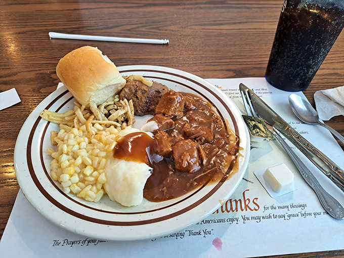 Behold the beef tips and gravy—tender chunks swimming in a savory sea, paired with buttery mashed potatoes and sweet corn. Heaven on a plate.