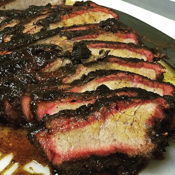Behold the brisket that launched a thousand road trips. That pink smoke ring is the BBQ equivalent of a Michelin star.