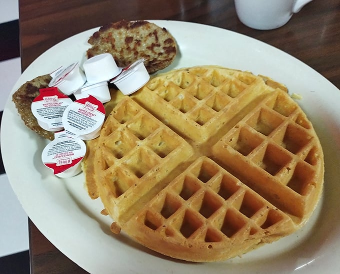 Golden perfection in waffle form—those deep squares aren't just for show, they're strategic syrup reservoirs designed by breakfast engineers.