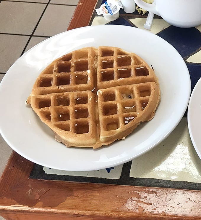 This Belgian waffle isn't trying to impress Instagram—it's too busy being perfectly golden, waiting for that maple syrup waterfall.
