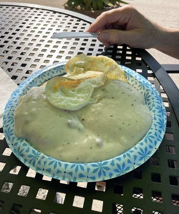 Biscuits and gravy so creamy they should require a lifeguard on duty. That pepper-speckled gravy river deserves respect.