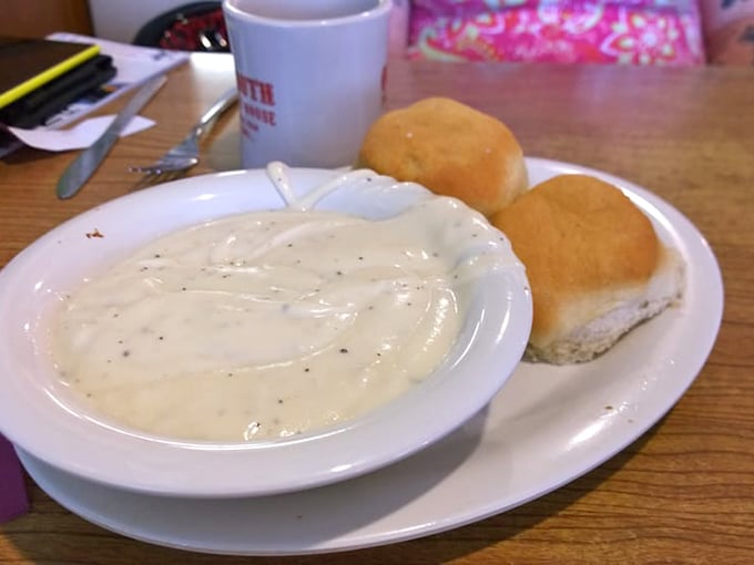 Behold the holy grail of comfort food—biscuits and gravy that would make your grandmother both proud and jealous. That pepper-speckled gravy means business.