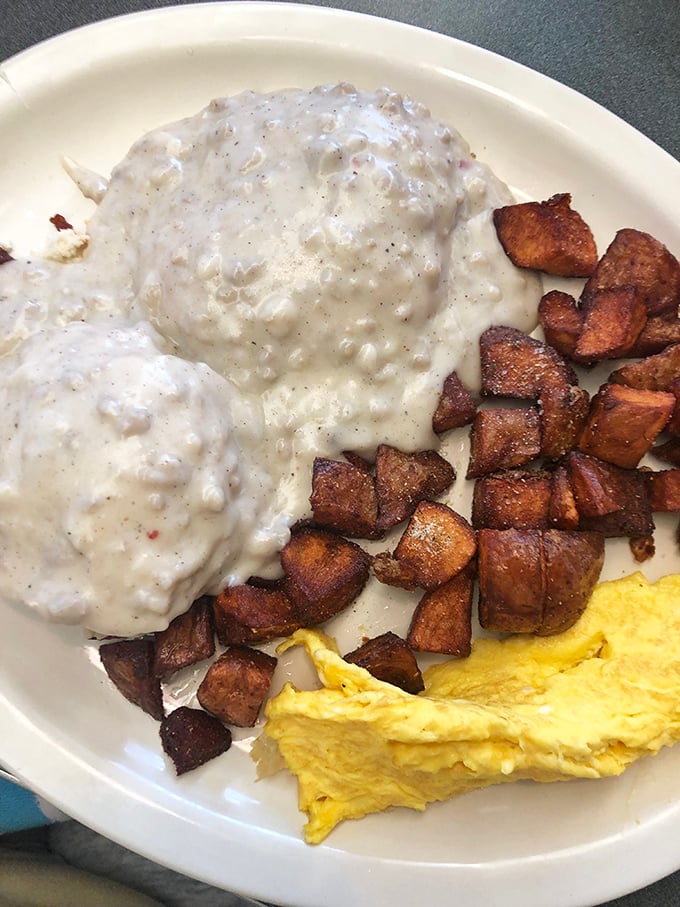 Biscuits and gravy that make you question every other version you've ever had. Those home fries look like they've achieved the perfect crisp-to-tender ratio—the holy grail of potato preparation.
