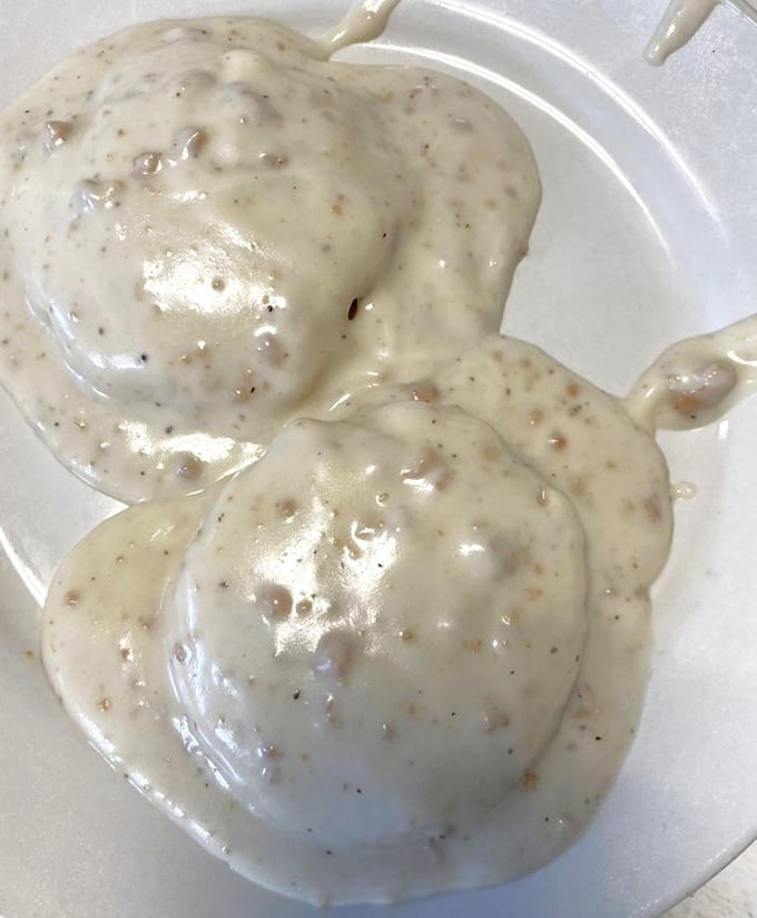 Behold the star attraction: biscuits smothered in creamy, peppery sausage gravy. These fluffy islands of dough swimming in savory goodness might just change your life.