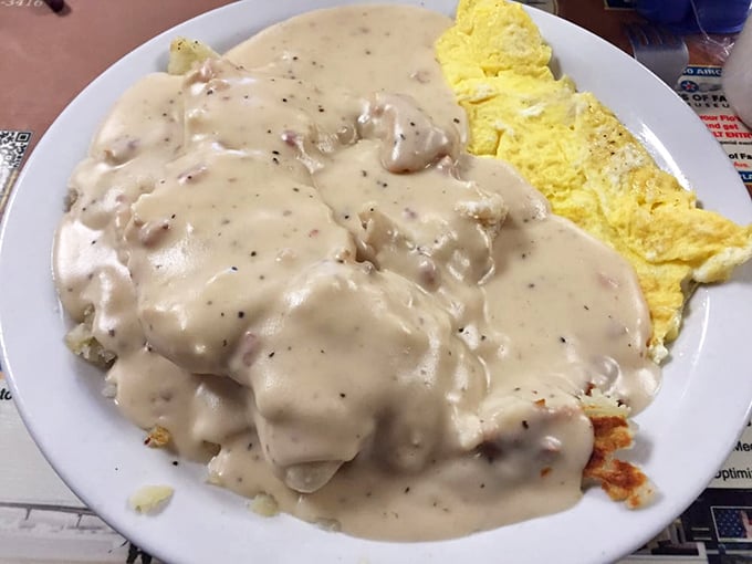 Behold the crown jewel: biscuits drowning in a sea of peppery sausage gravy that would make your cardiologist wince and your taste buds sing hallelujah.