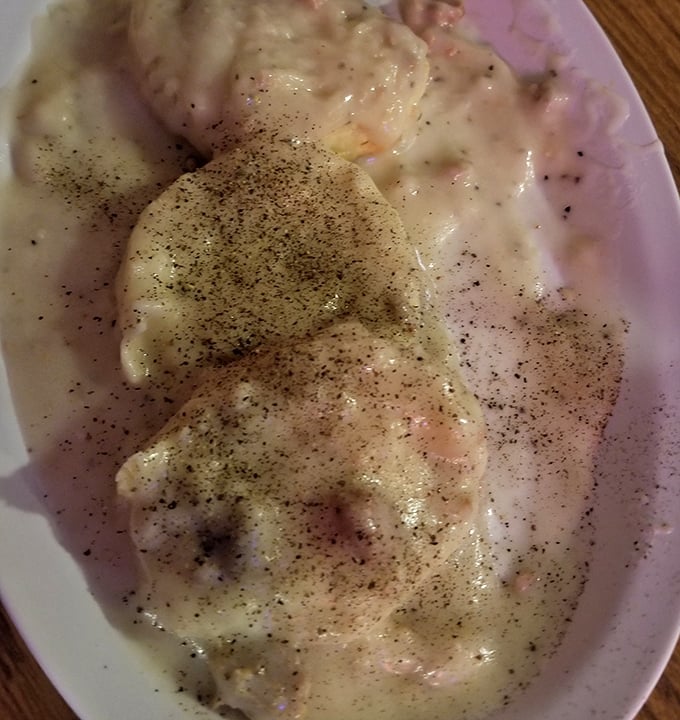 Biscuits and gravy so good they should require a permission slip. That pepper sprinkle isn't decoration—it's an exclamation point.