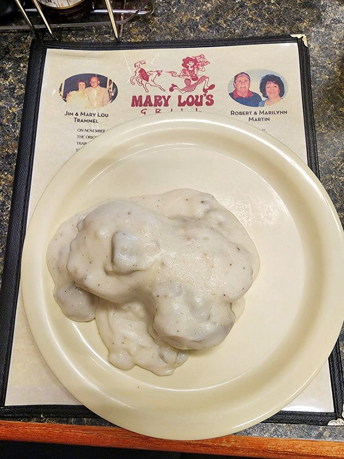 Behold the holy grail of Southern Illinois breakfast—biscuits drowning in creamy, peppery sausage gravy that would make your grandmother weep with joy.