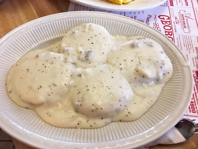 Behold the holy grail of comfort food! Flaky biscuits swimming in peppery sausage gravy – a plate that whispers, "Go back to bed after this."